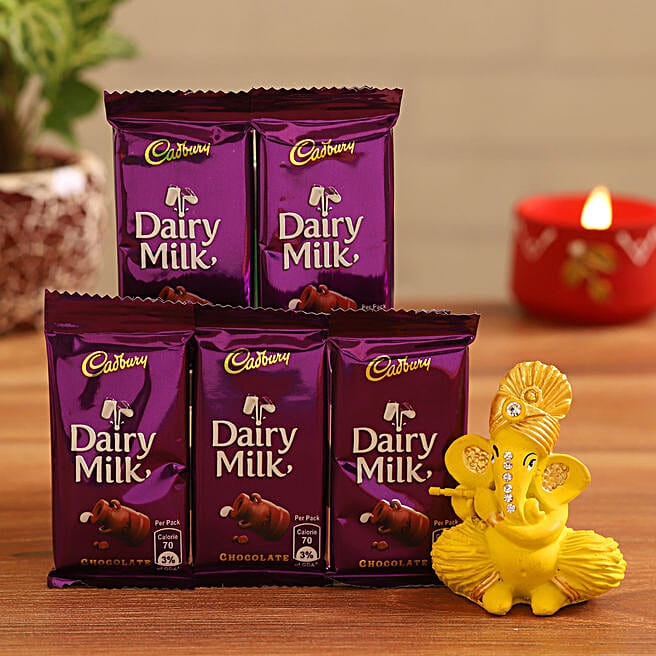 Buy/Send Yellow Flute Ganesha Idol & Dairy Milk Combo Online- FNP