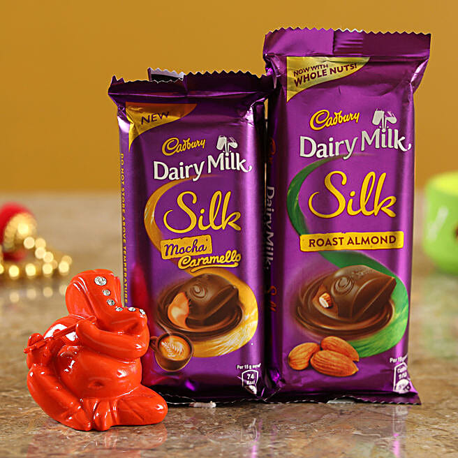 Buy/Send Dairy Milk Combo With Orange Ganesha Idol Online- Ferns N Petals