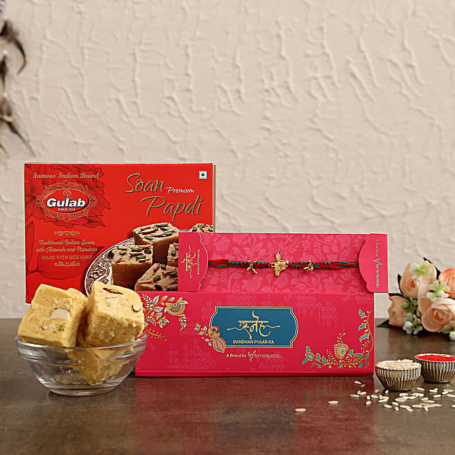Buy/Send Lord Ganesha Rakhi & Soan Papdi Box Online- FNP