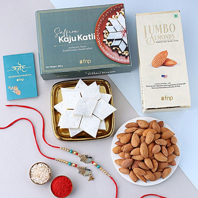 Buy/Send Bhaiya Bhabhi Peacock Rakhi-Nuts and Sweets Combo Online- FNP