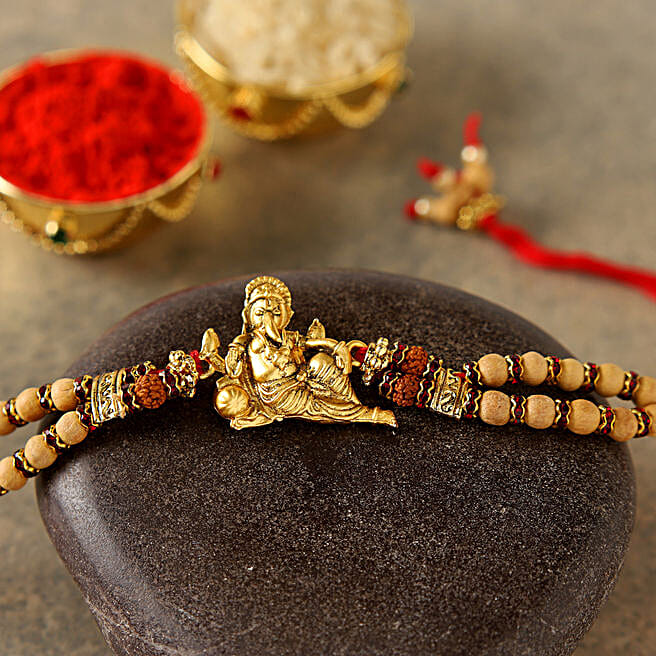 Golden Ganesha Rudraksh Rakhi norway | Gift Golden Ganesha Rudraksh ...