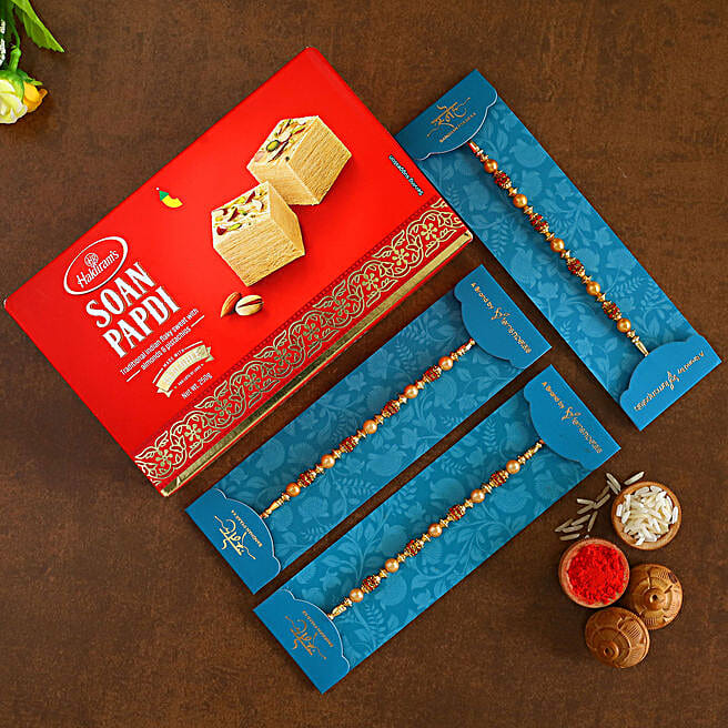 Traditional Pearl Studded Rakhi Trio And Soan Papdi qatar | Gift ...